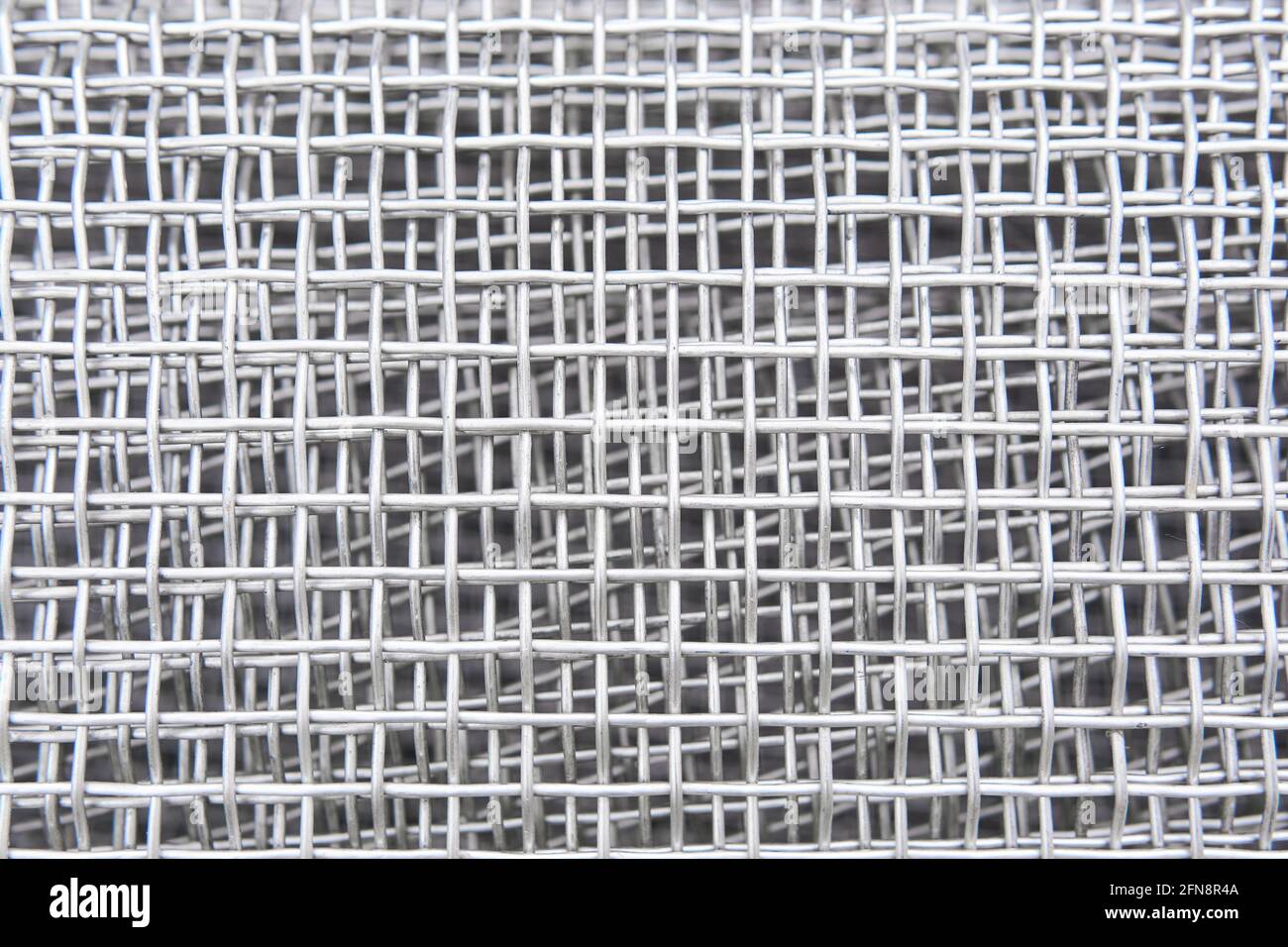 abstract industrial background - roll of galvanized metal mesh close up ...