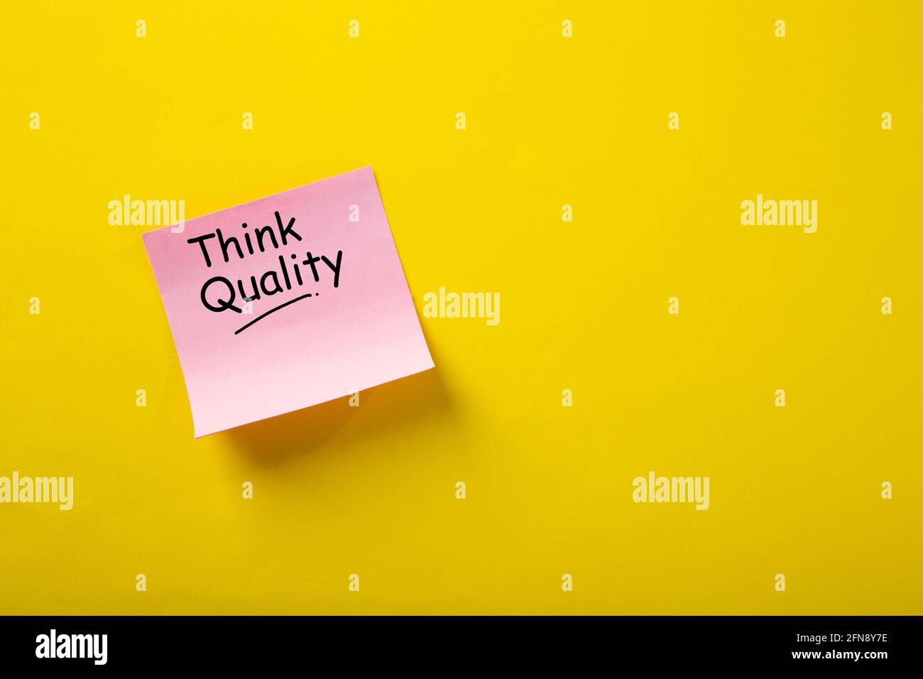 Think Quality word concept on sticky note against yellow background ...