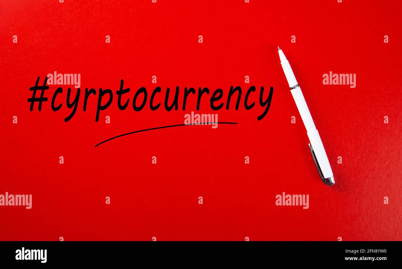 The word cryptocurrency hand written with hashtag symbol and a pen ...