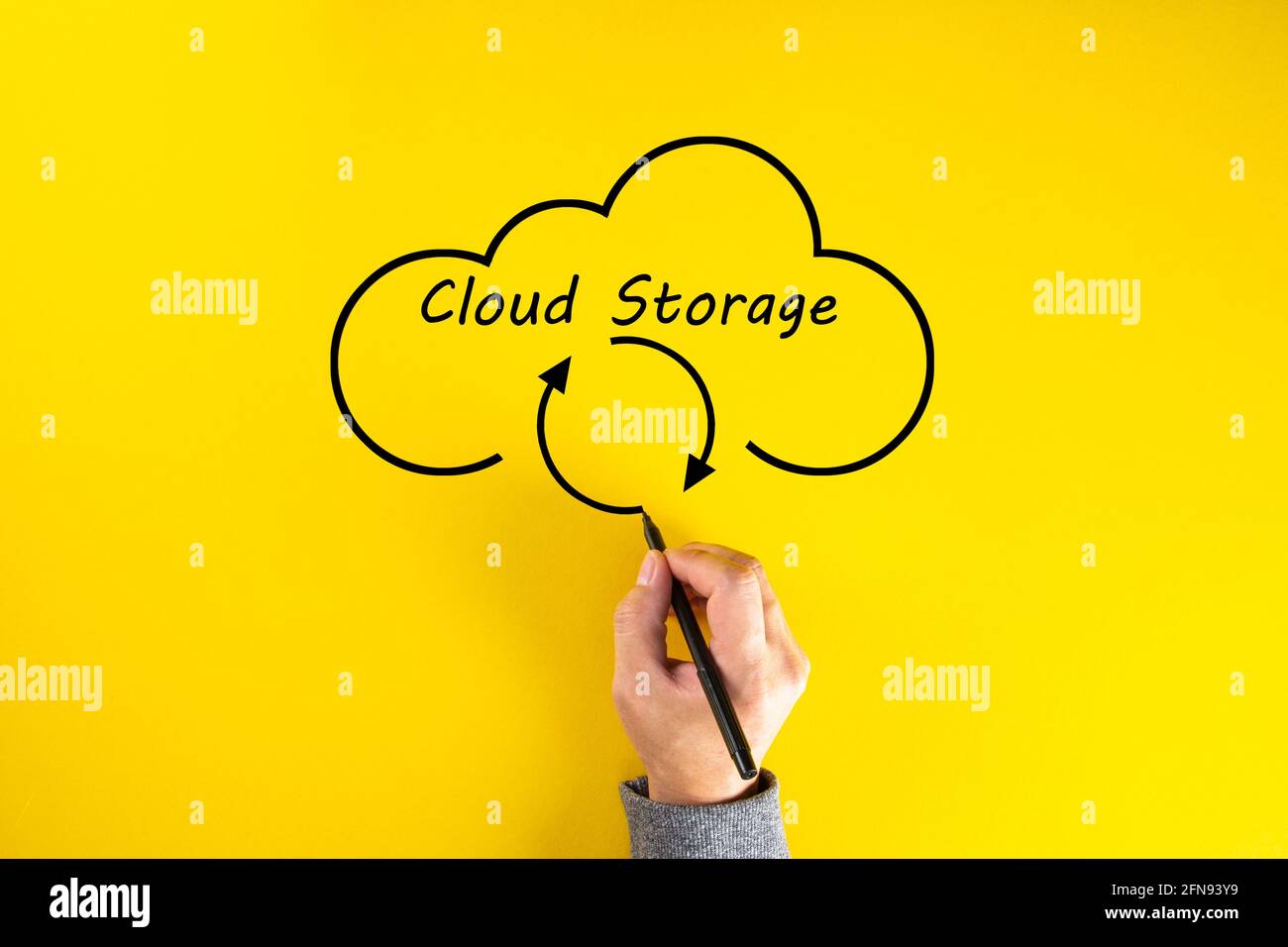 Human hand drawing cloud storage on yellow background. Data storage ...