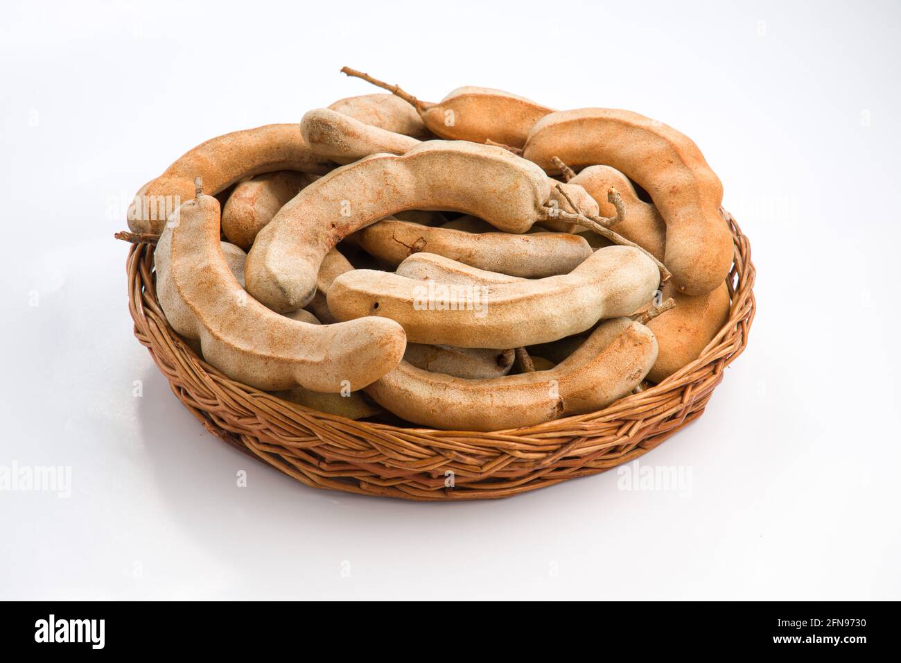 Tamarind bean like pods filled with seeds surrounded by a fibrous pulp ...