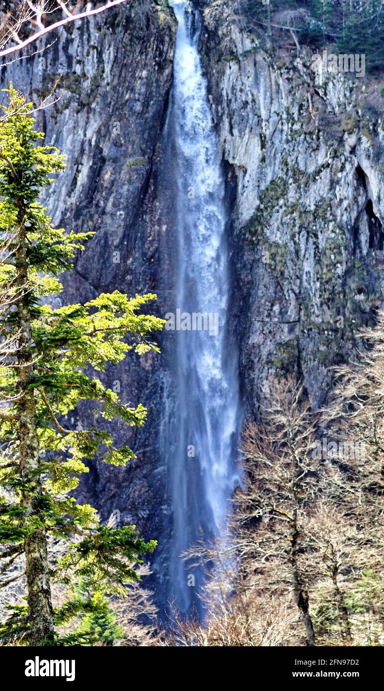 Natural view of a rocky cliff with a breathtaking waterfall Stock Photo ...