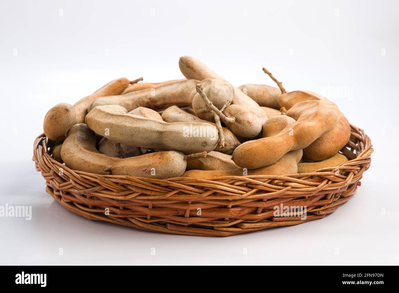 Tamarind bean like pods filled with seeds surrounded by a fibrous pulp ...