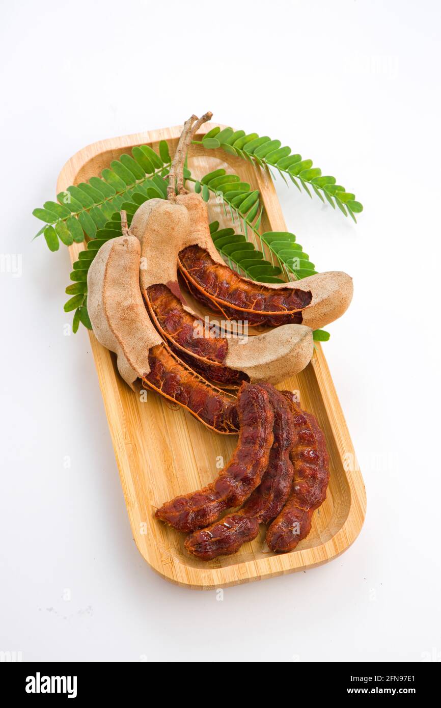 Tamarind bean like pods filled with seeds surrounded by a fibrous pulp ...