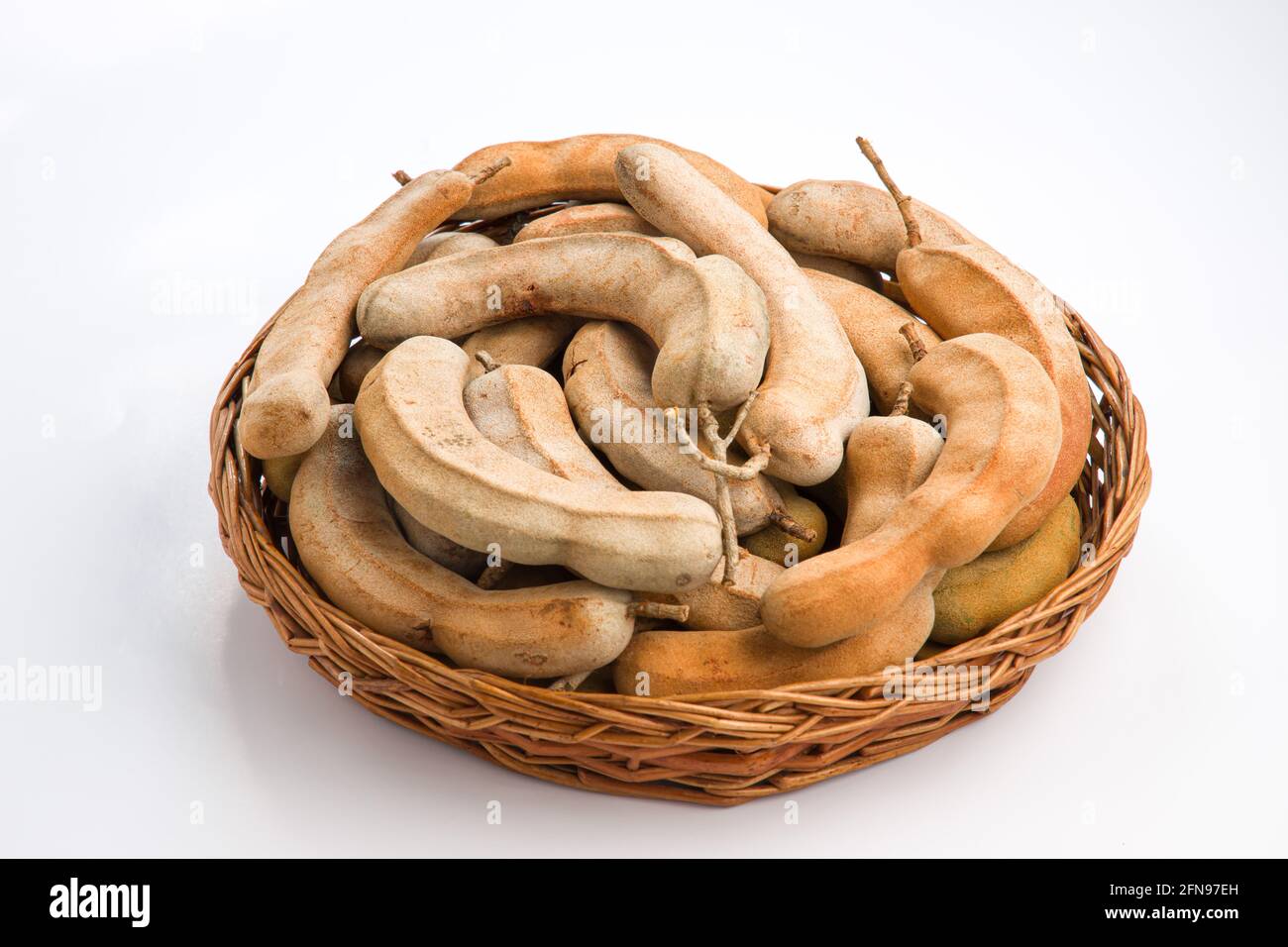 Tamarind bean like pods filled with seeds surrounded by a fibrous pulp ...