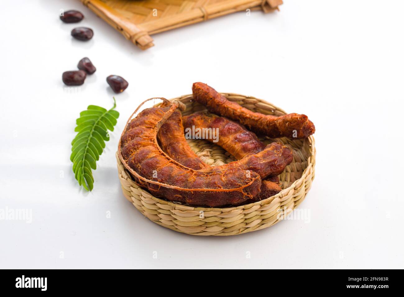 Tamarind bean like pods filled with seeds surrounded by a fibrous pulp ...