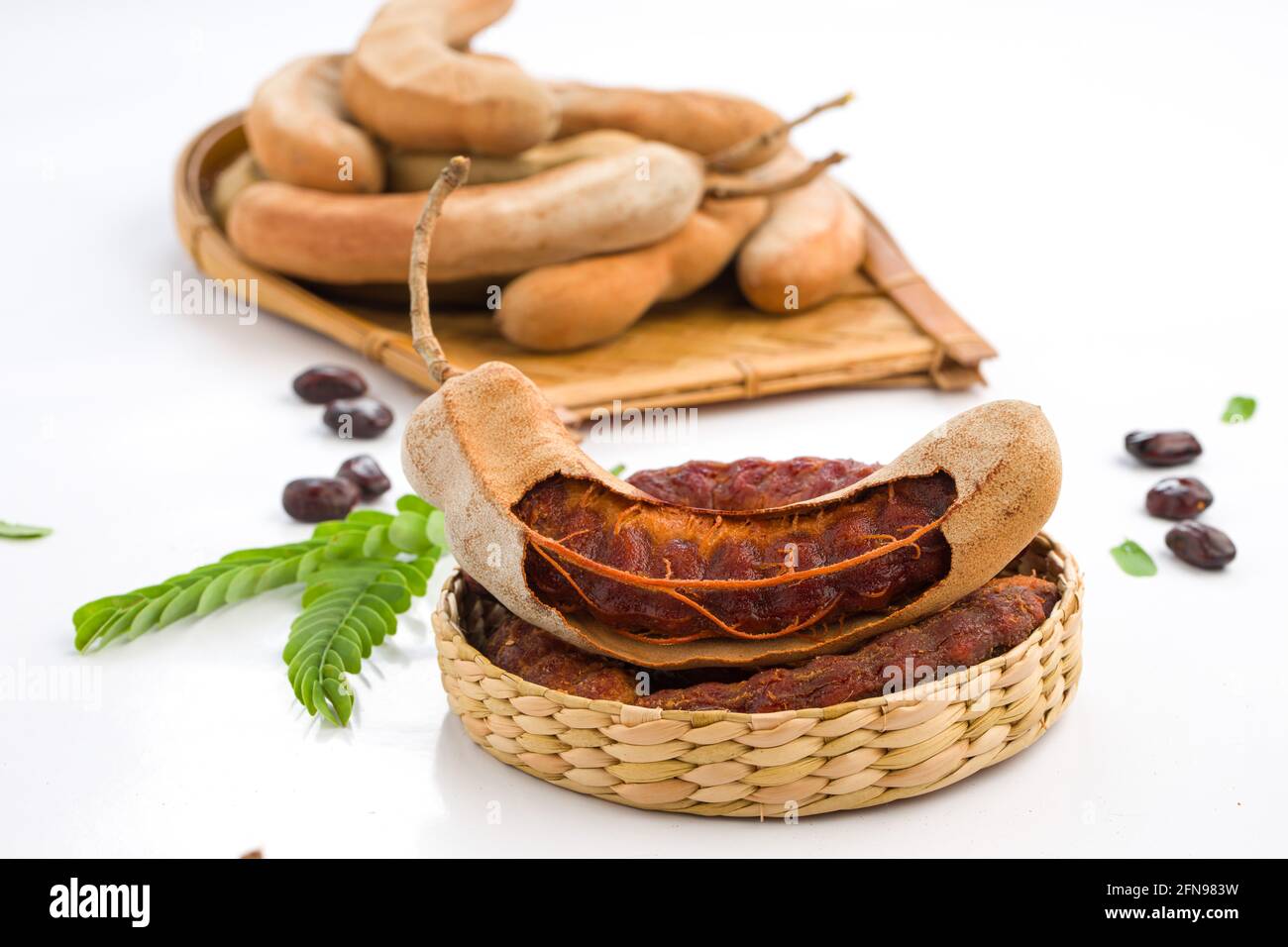 Tamarind bean like pods filled with seeds surrounded by a fibrous pulp ...