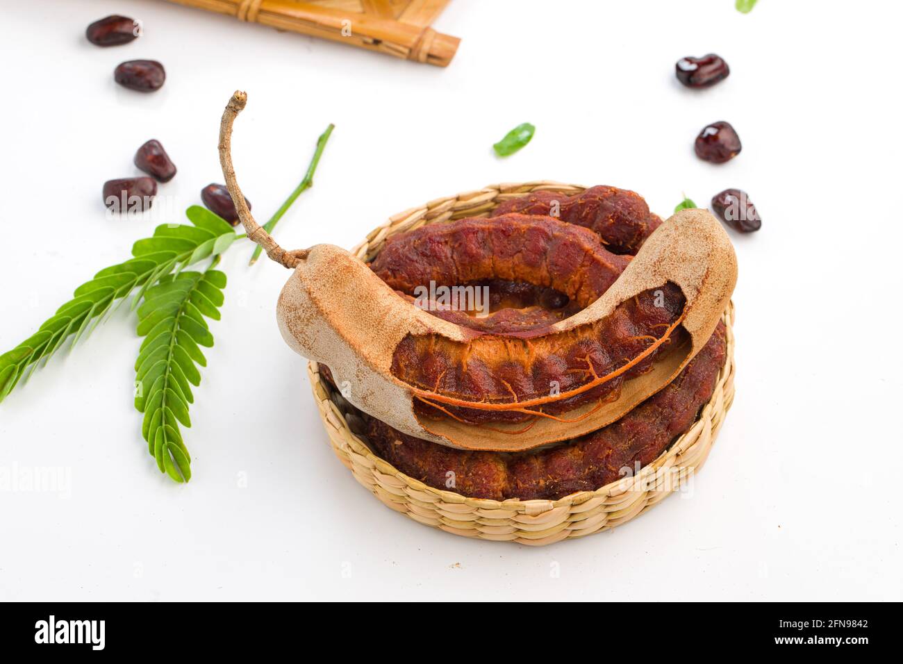 Tamarind bean like pods filled with seeds surrounded by a fibrous pulp ...