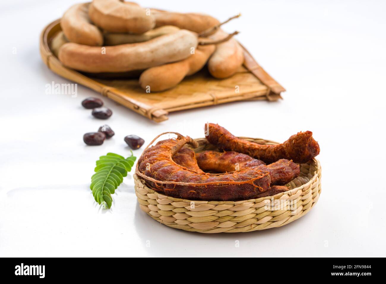 Tamarind bean like pods filled with seeds surrounded by a fibrous pulp ...