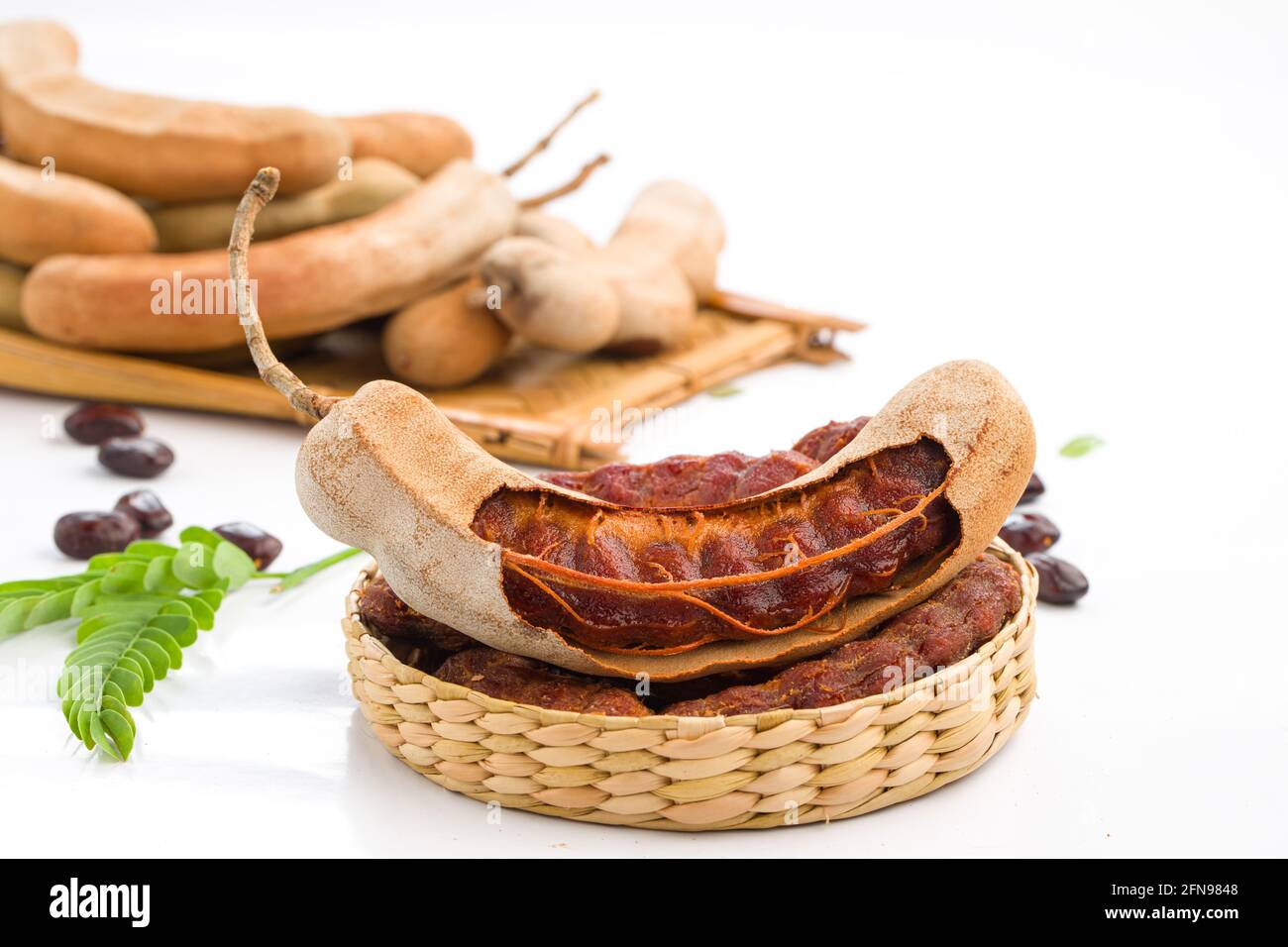 Tamarind bean like pods filled with seeds surrounded by a fibrous pulp ...