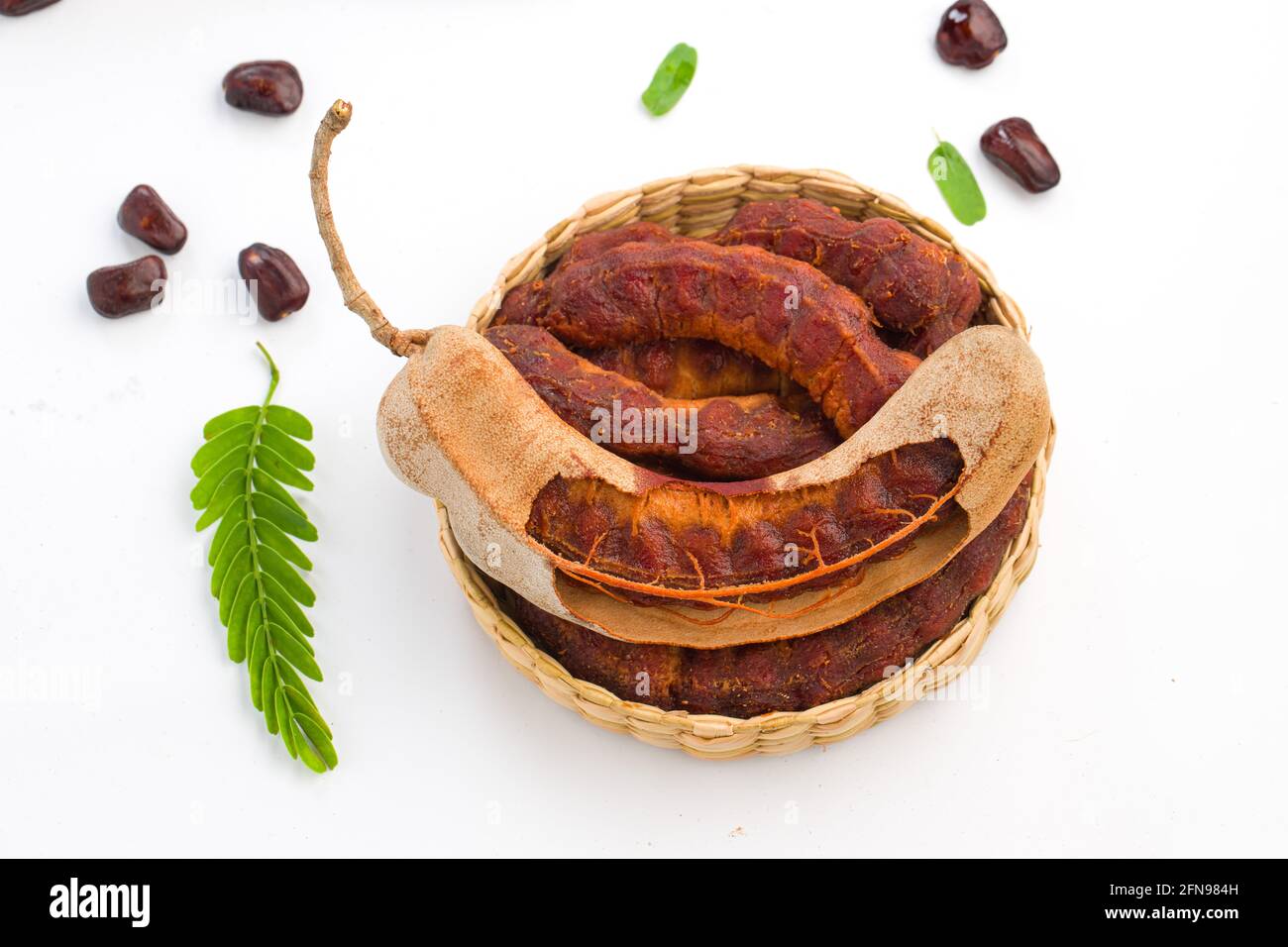 Tamarind bean like pods filled with seeds surrounded by a fibrous pulp ...
