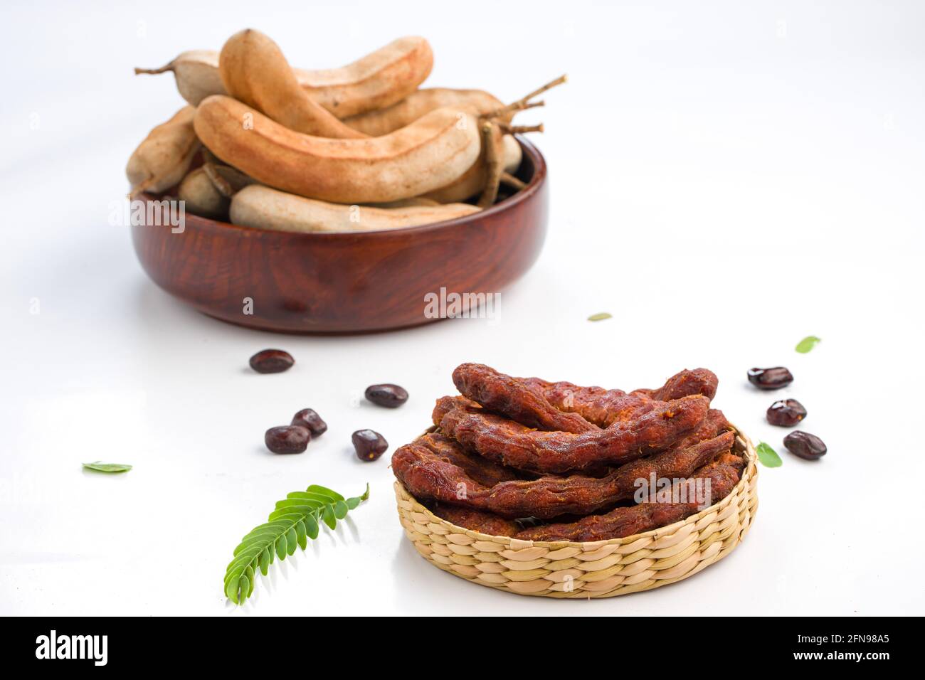 Tamarind bean like pods filled with seeds surrounded by a fibrous pulp ...