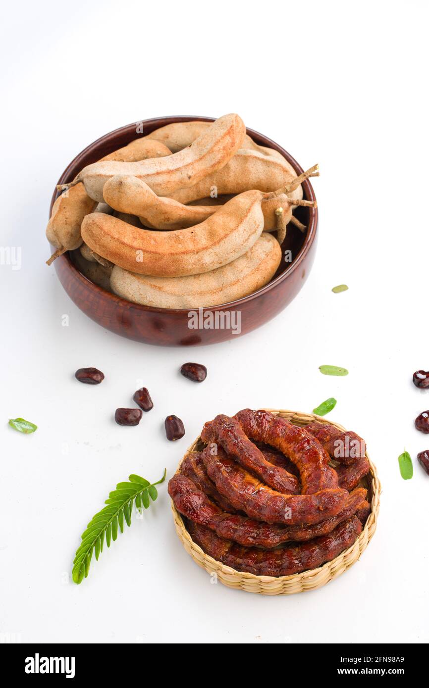 Tamarind bean like pods filled with seeds surrounded by a fibrous pulp ...