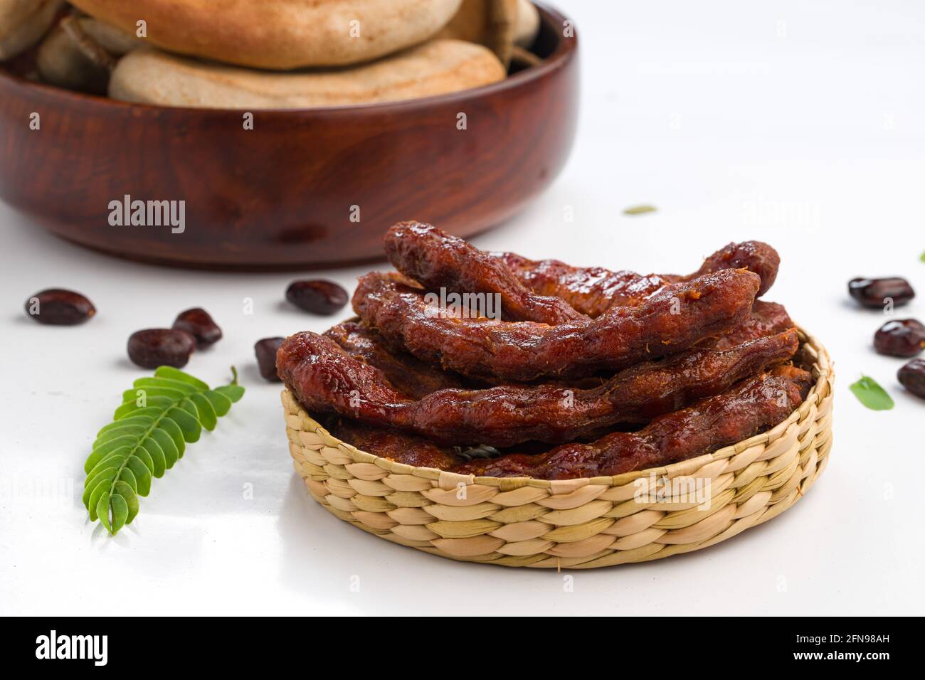 Tamarind bean like pods filled with seeds surrounded by a fibrous pulp ...