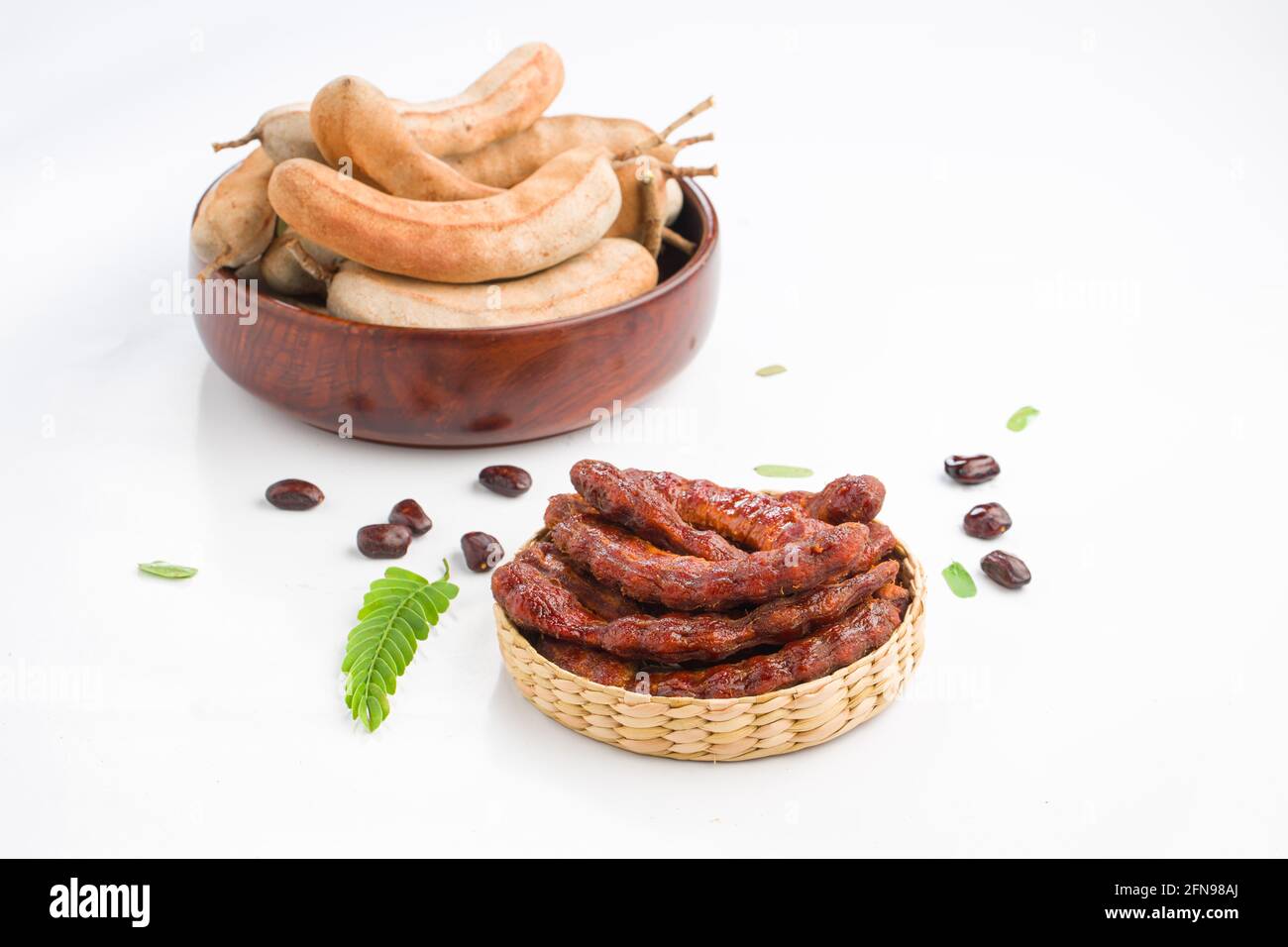 Tamarind bean like pods filled with seeds surrounded by a fibrous pulp ...