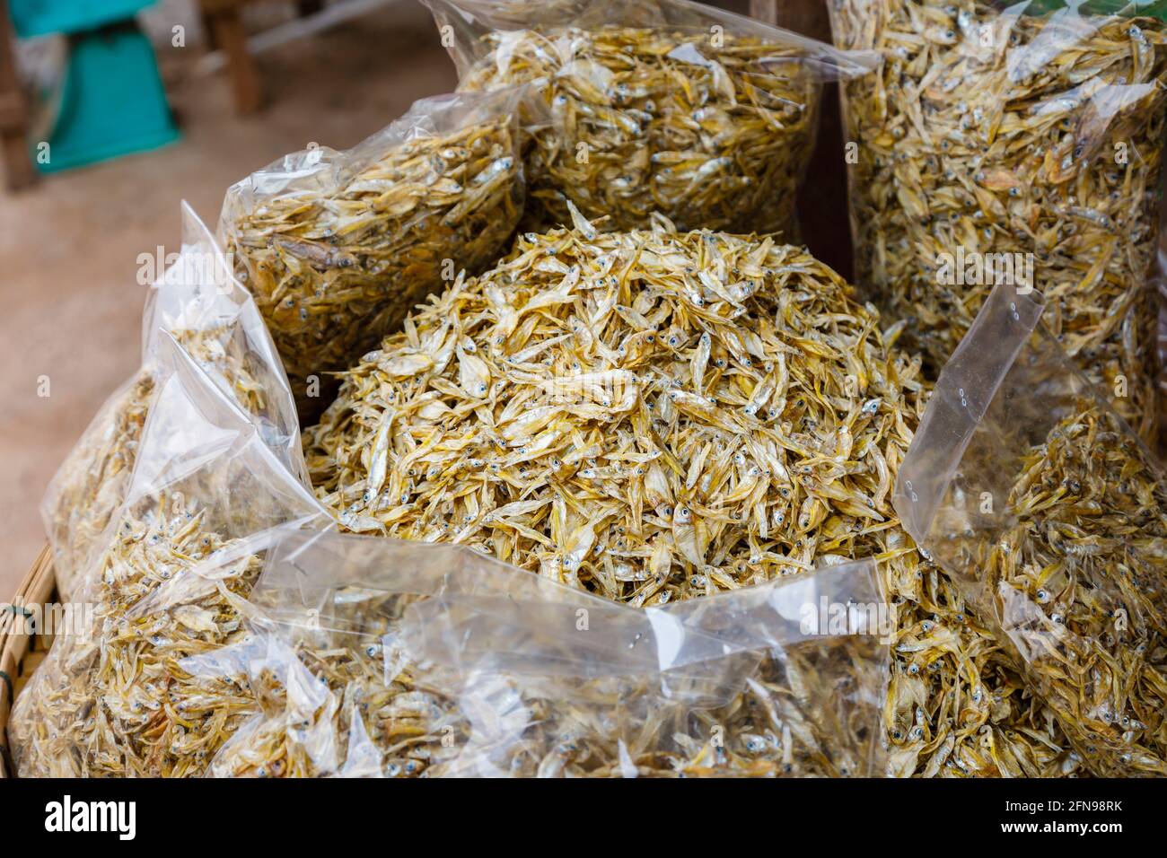 Plastic sacks full of smelly small dried fish at the fish market at Tha ...