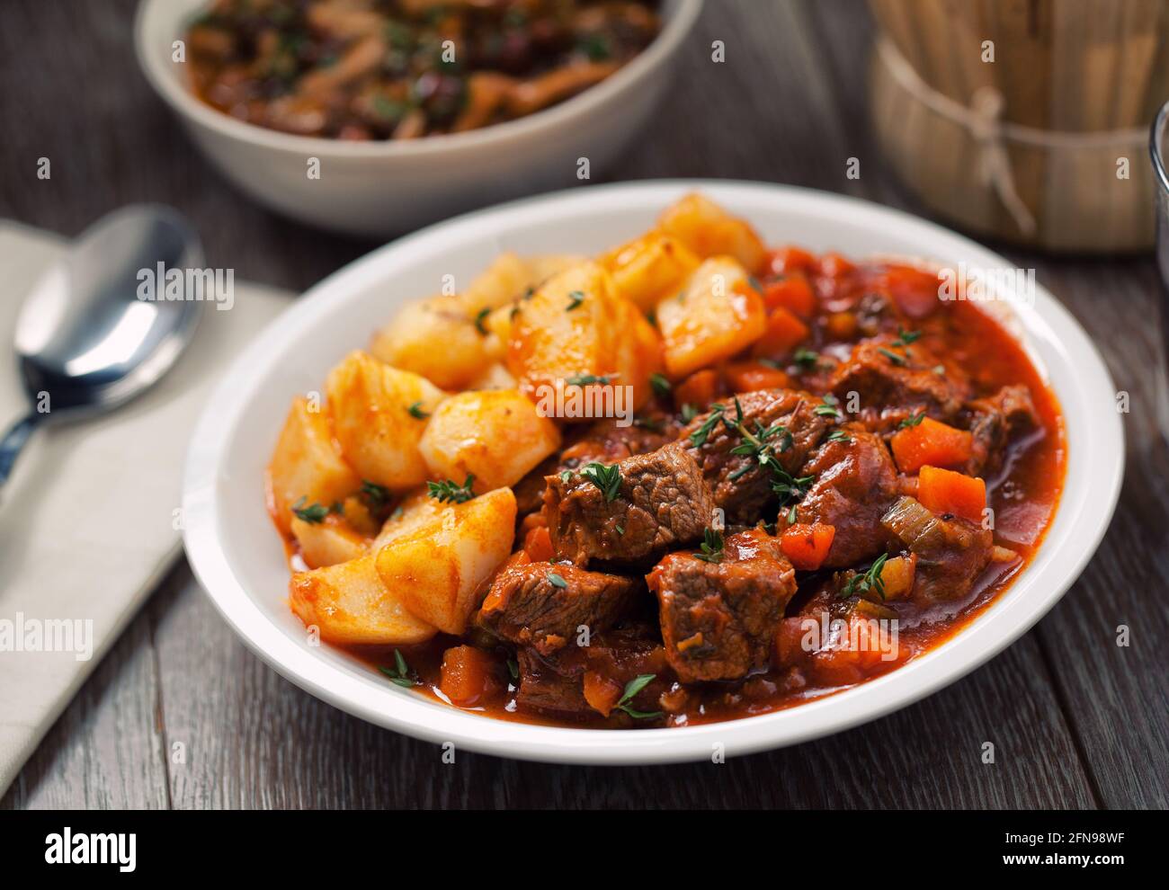 Hot stew with mushrooms and potatoes on a plate Stock Photo - Alamy