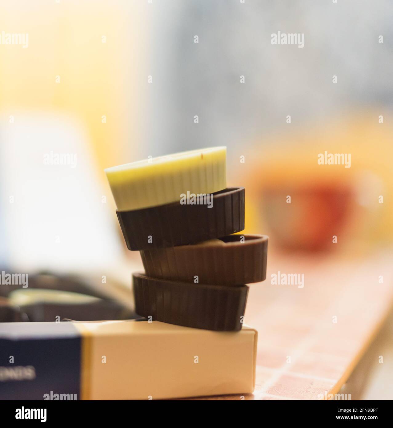 Four chocolate candies in the box, closeup of chocolate sweets, blurred ...