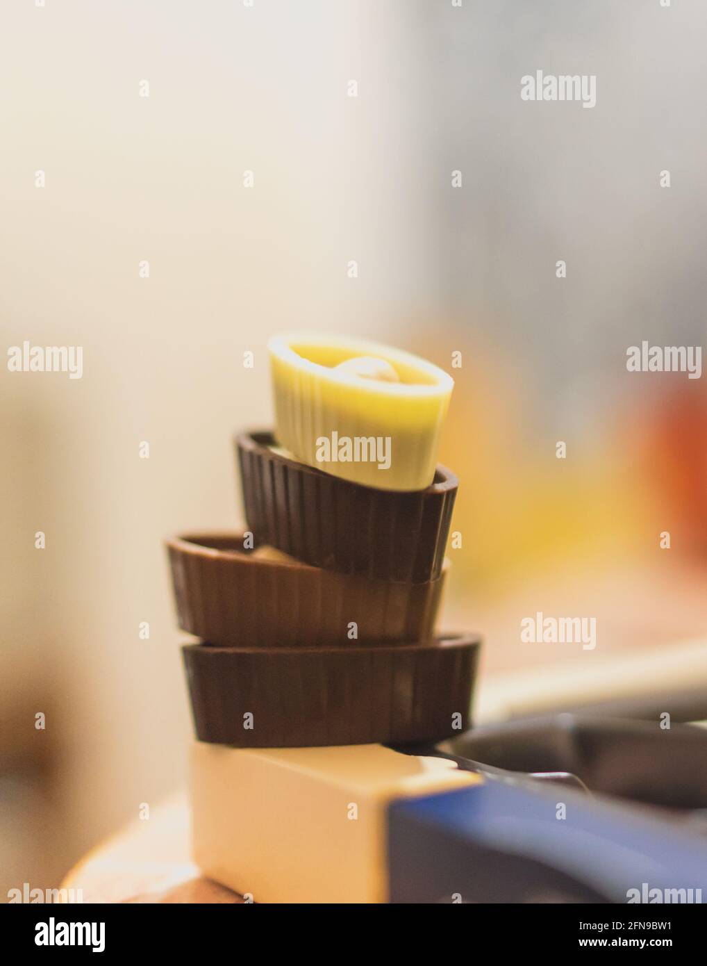 Four chocolate candies in the box, closeup of chocolate sweets, blurred ...