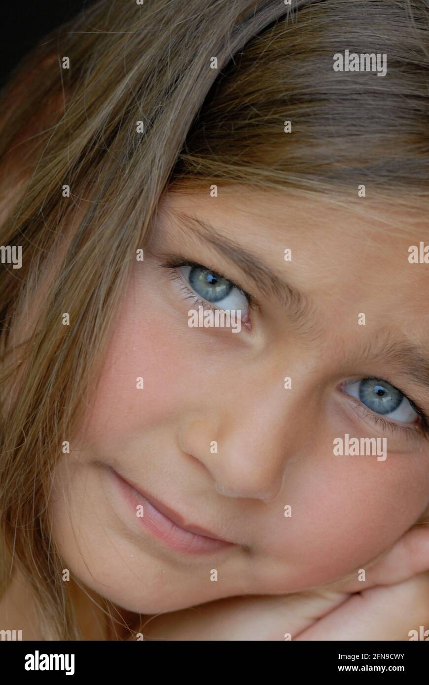 Little girl blonde hair, blue eyes and white dress, that makes grimaces ...