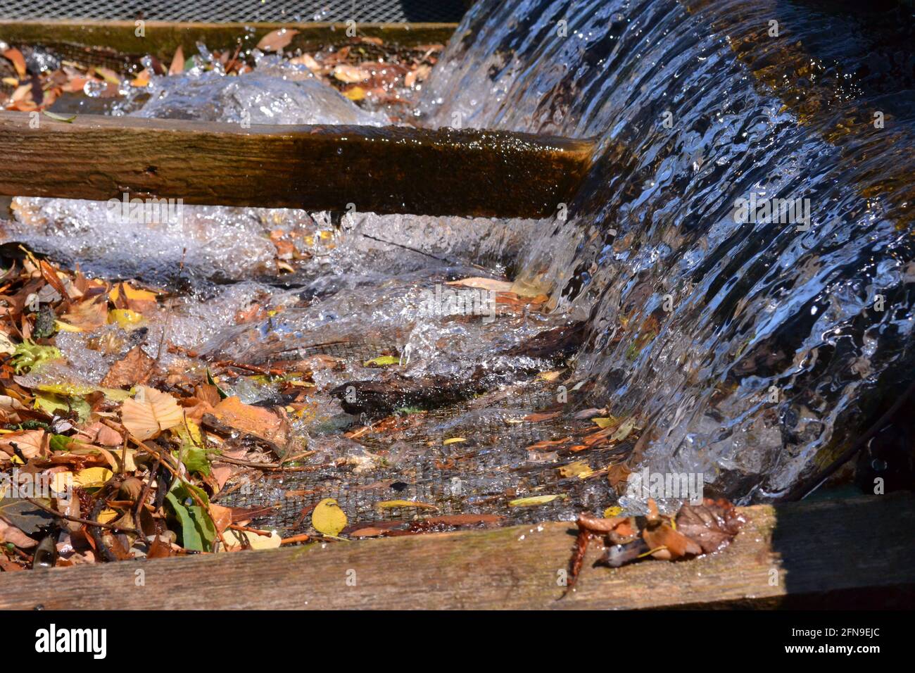 Small waterfall on cascades of fish farming tanks in the mountains in ...