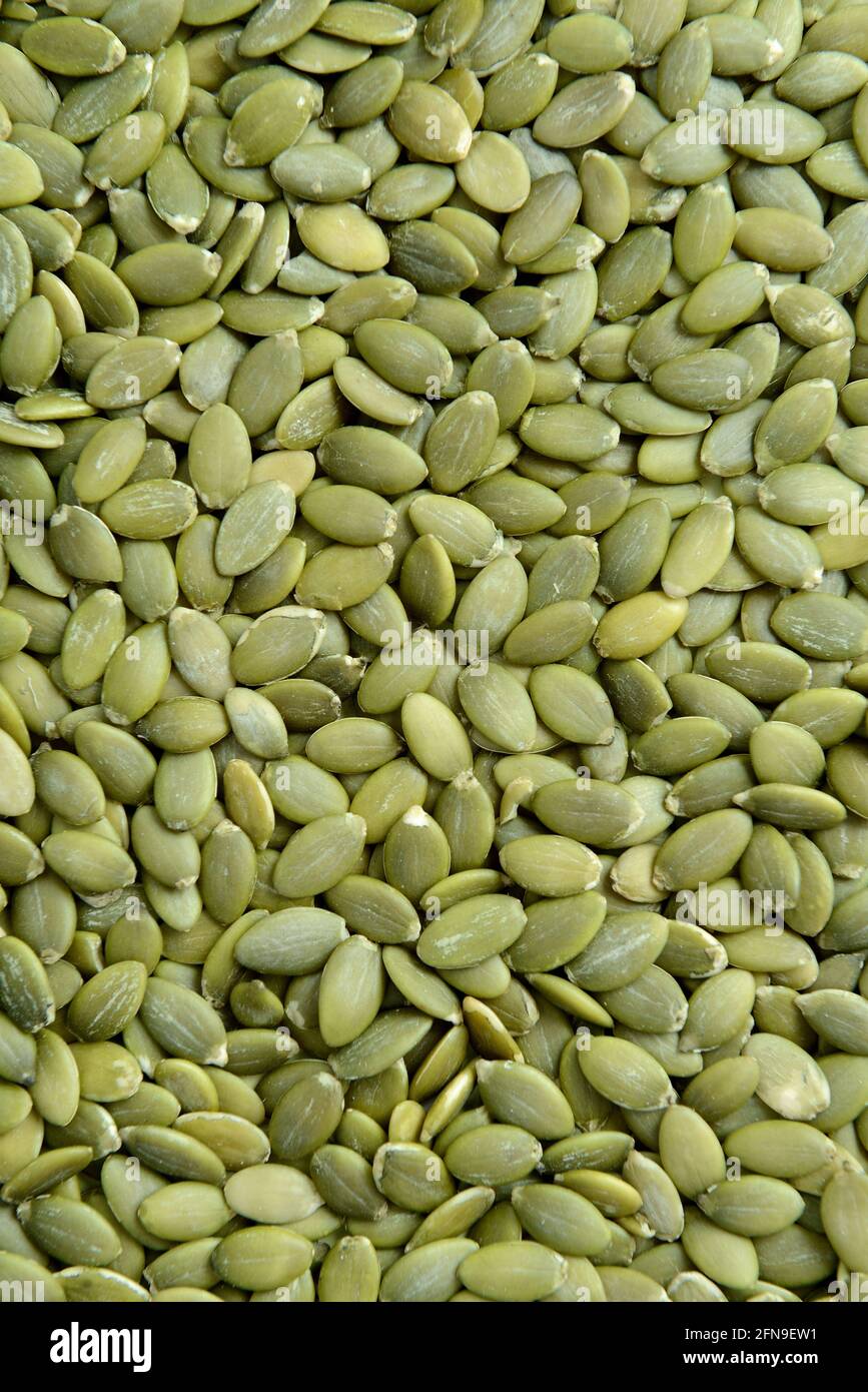 Green color raw whole hulled Pumpkin seeds Stock Photo - Alamy