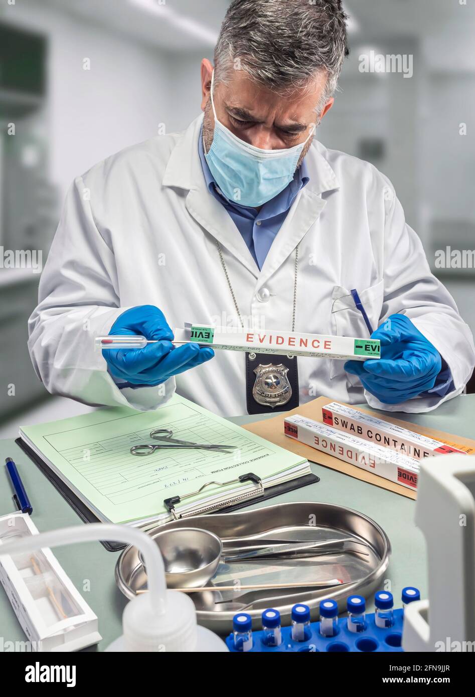 Police expert extracts traces of blood in a swab for analysis in the ...