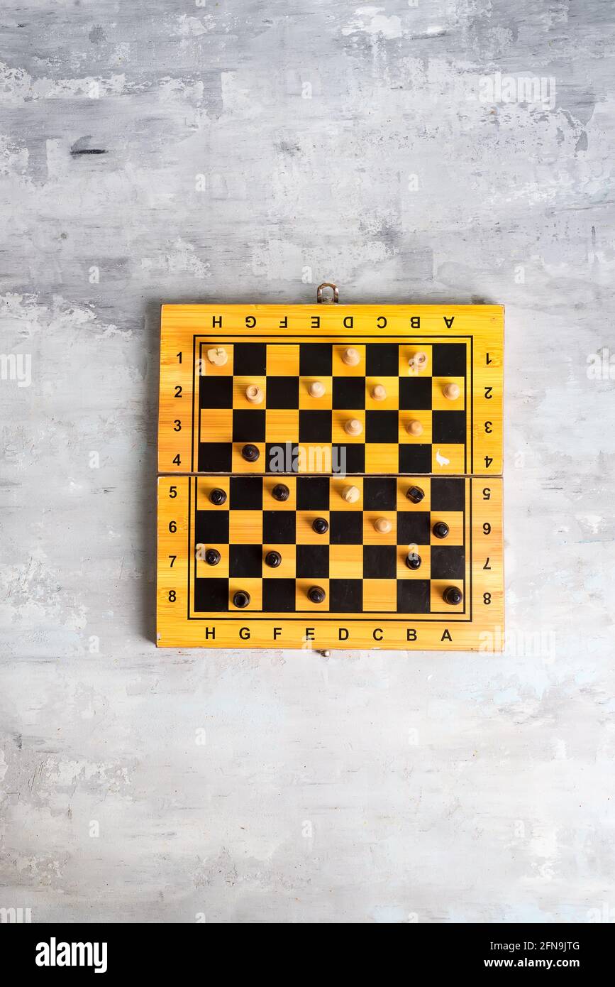wooden chess board and making chess move on stone background, flat lay ...