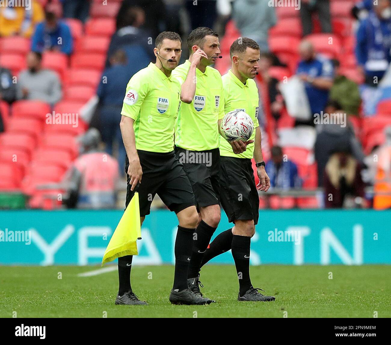 Referee Michael Oliver (centre) alongside linesmen Stuart Burt and ...