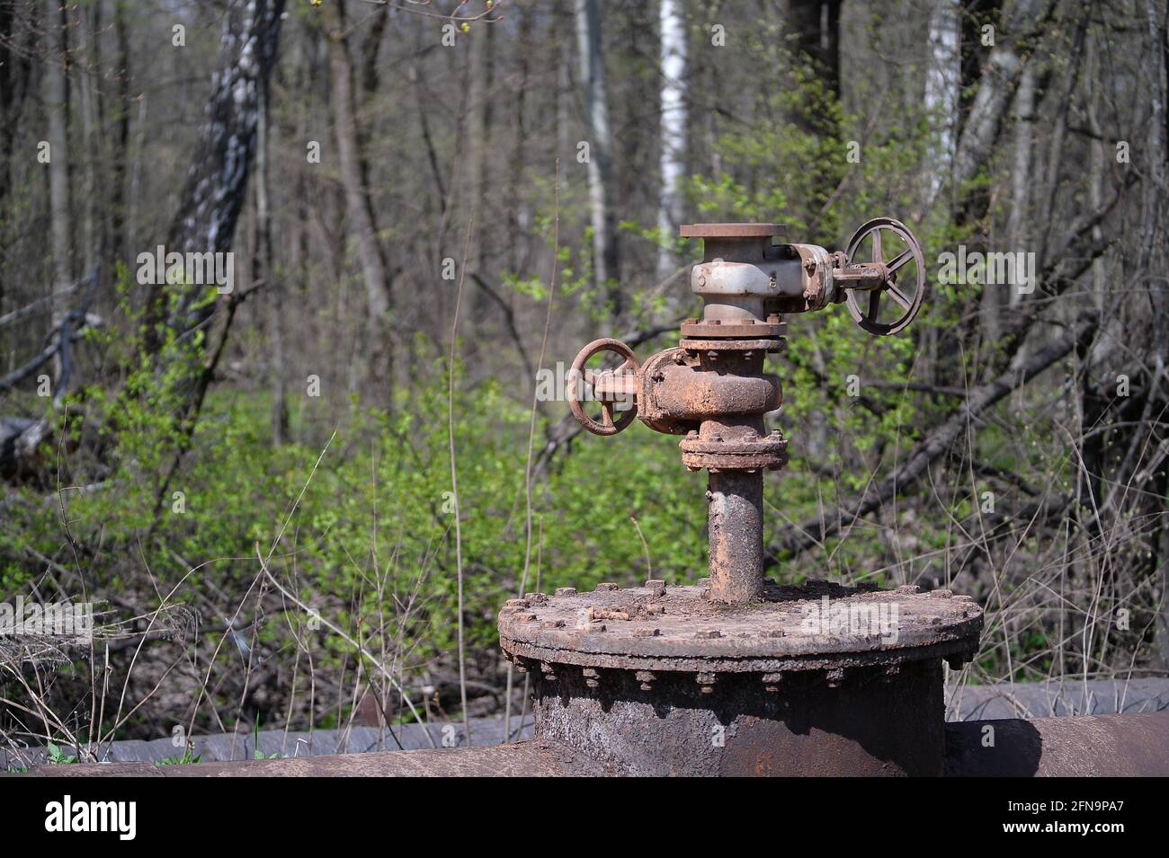 A hydrant on an industrial water supply pipeline on the background of a ...