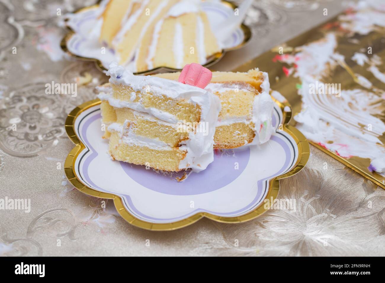 Top view of pieces of abirthday cake on plates isolated on a beige ...
