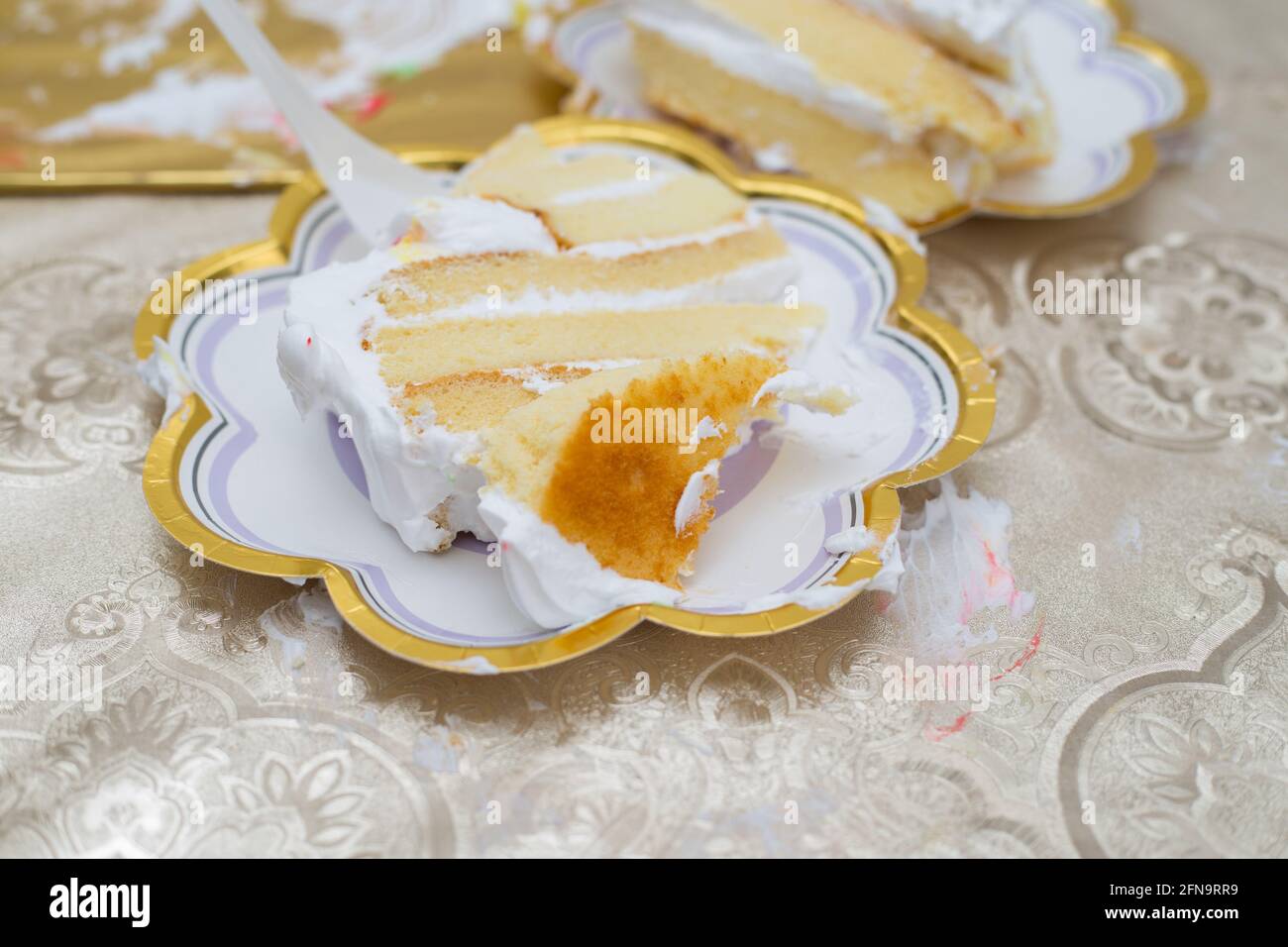 Top view of the pieces of a birthday cake on plates isolated on a beige ...