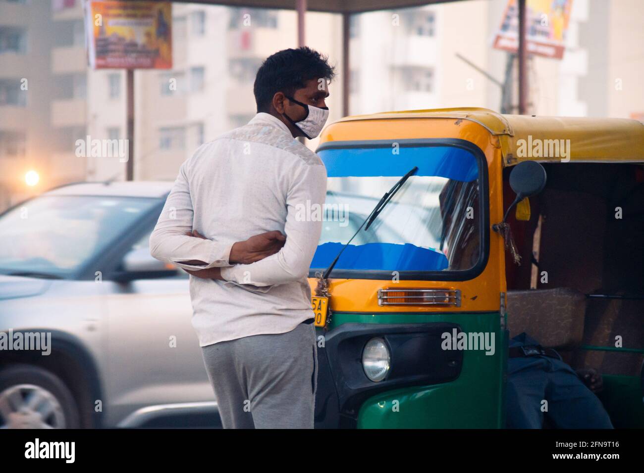 auto rickshaw driver in india standing wearing a mask with a infected ...
