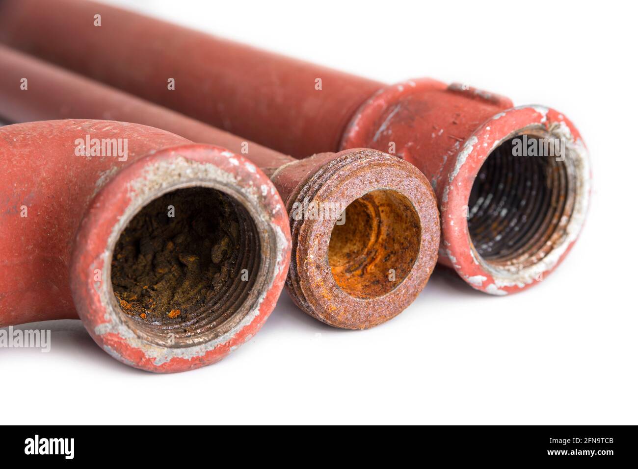 Used rusty metal thick pipes on a white Stock Photo - Alamy
