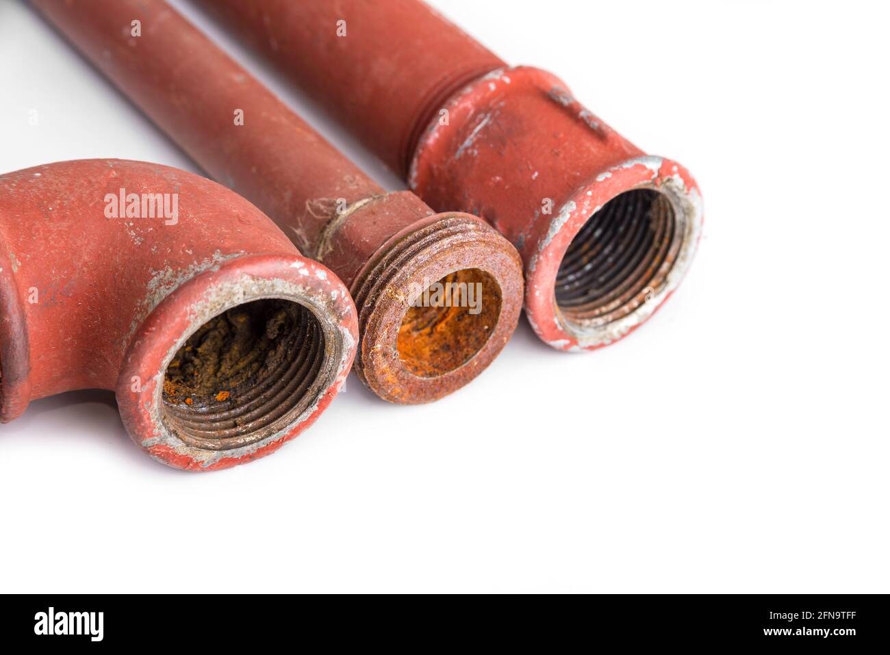 Used rusty metal thick pipes on a white Stock Photo - Alamy