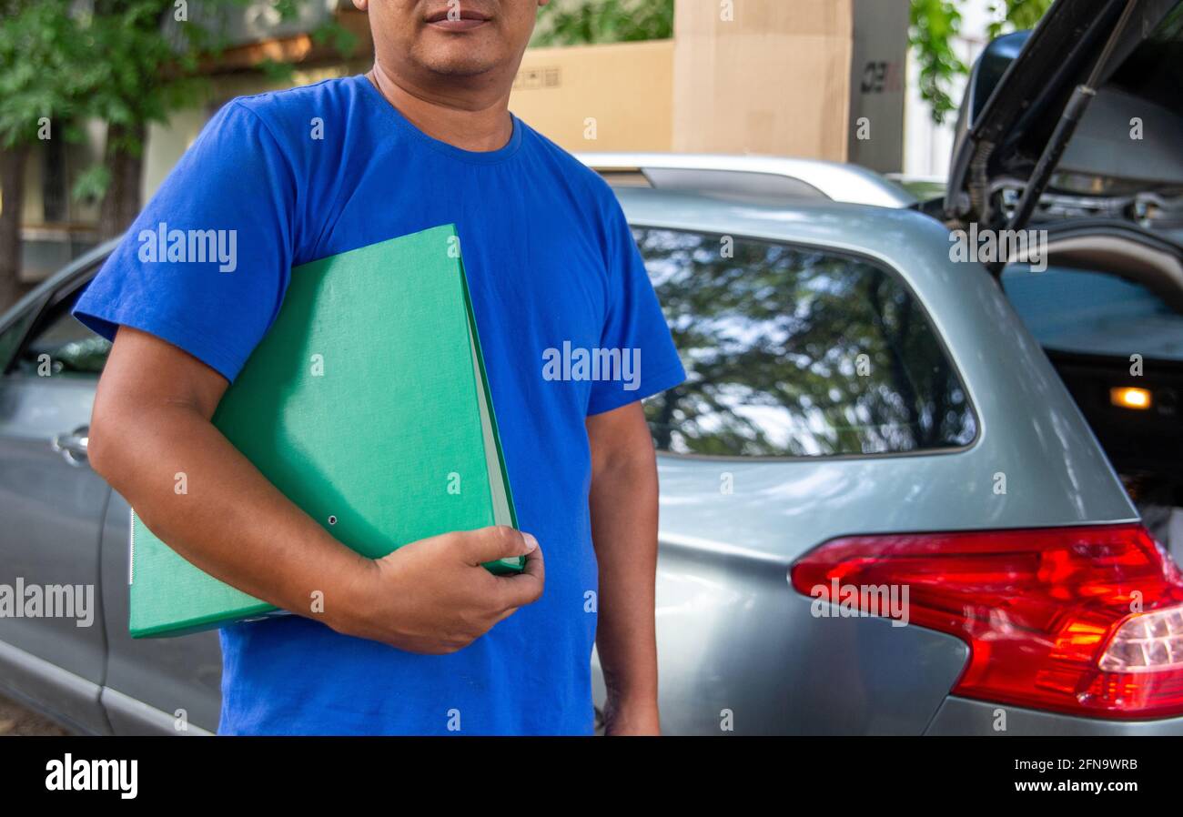 the courier with the documents delivers the parcel Stock Photo - Alamy