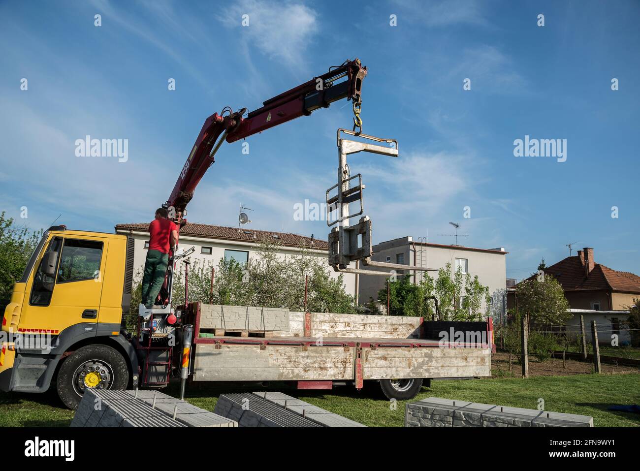 Unloading pallet from the truck with a crane Stock Photo - Alamy