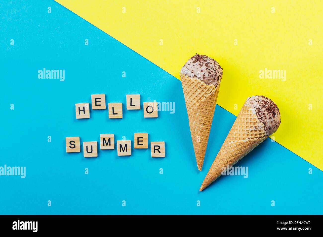 Chocolate Ice cream in waffle cone on blue and yellow background ...
