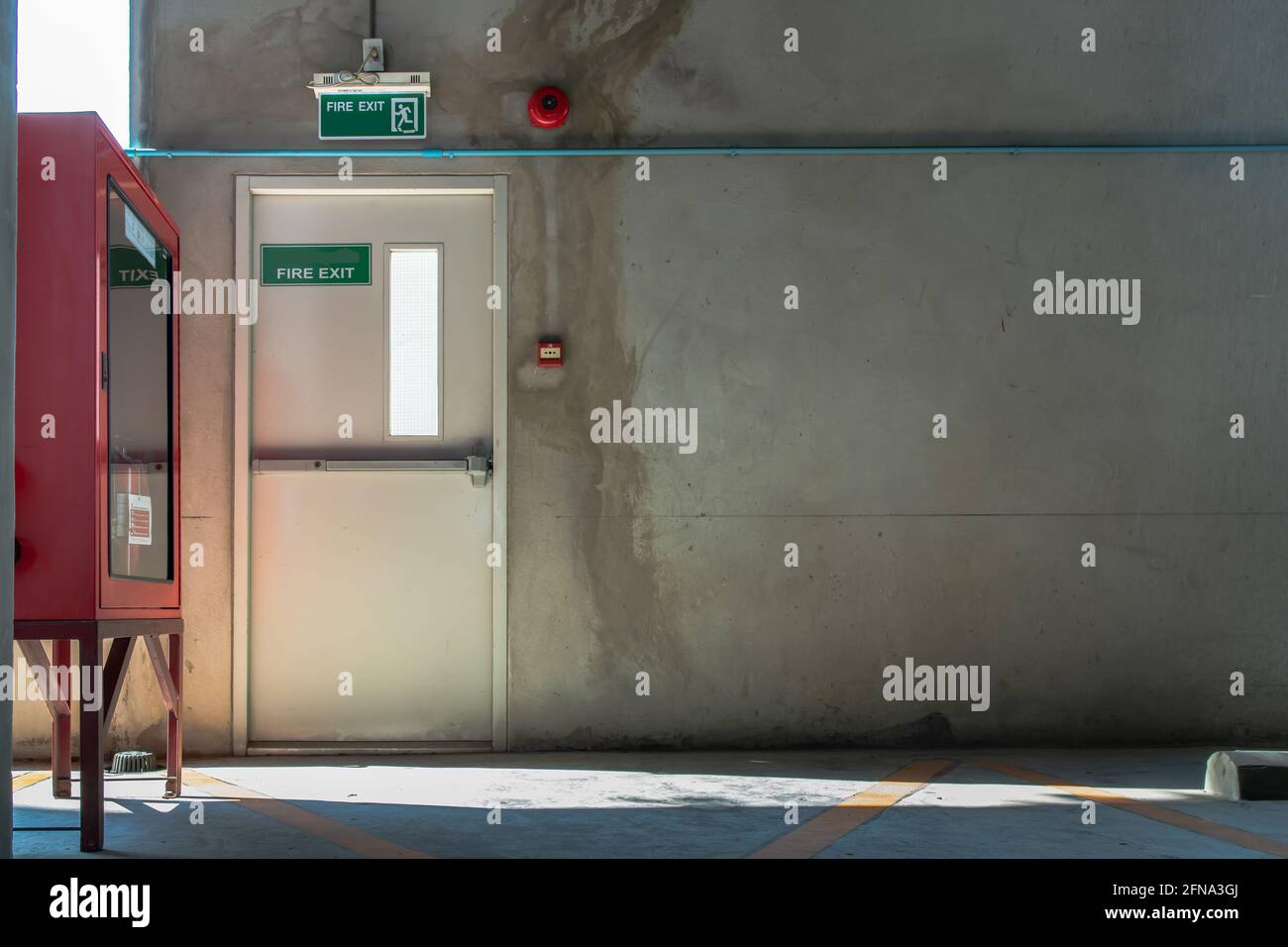 Fire exit door or Fire escape door with exit sign and Red fire fighting ...