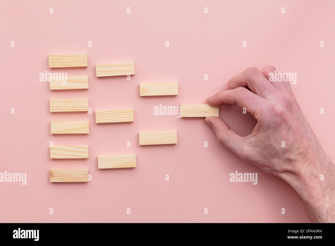 Hand choosing a wooden block from a flow chart. Business choice concept ...