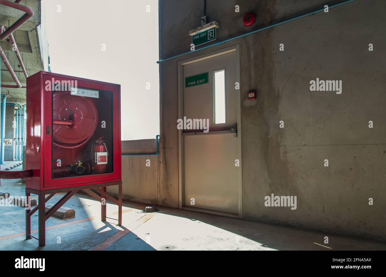 Fire exit door or Fire escape door with exit sign and Red fire fighting ...
