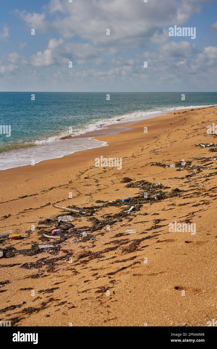 Poured trash on the beach - empty used dirty plastic bottles, packages ...