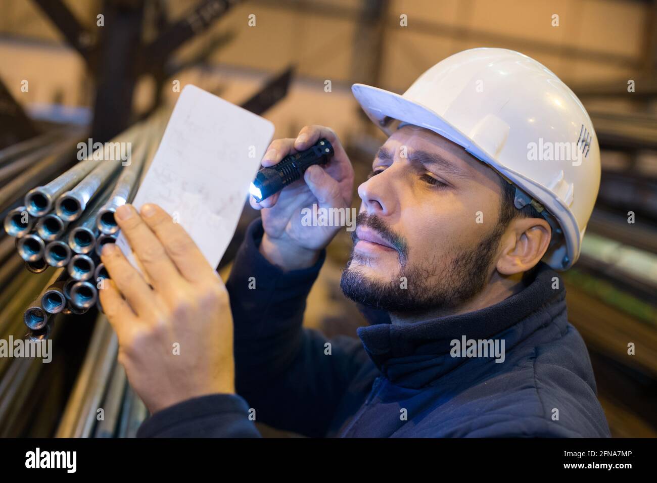 technician with torch checking metal tubes Stock Photo - Alamy