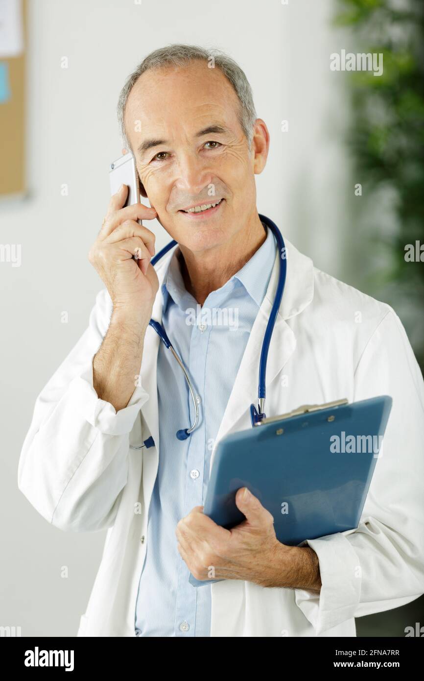 positive doctor talking on phone Stock Photo - Alamy