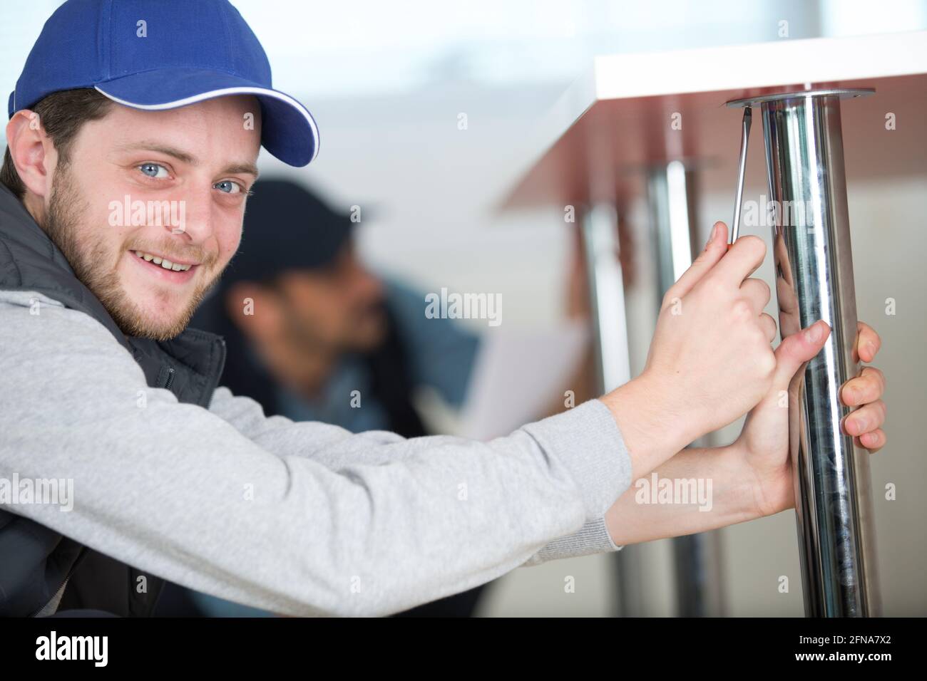 young fitter assembling a worktop support Stock Photo - Alamy