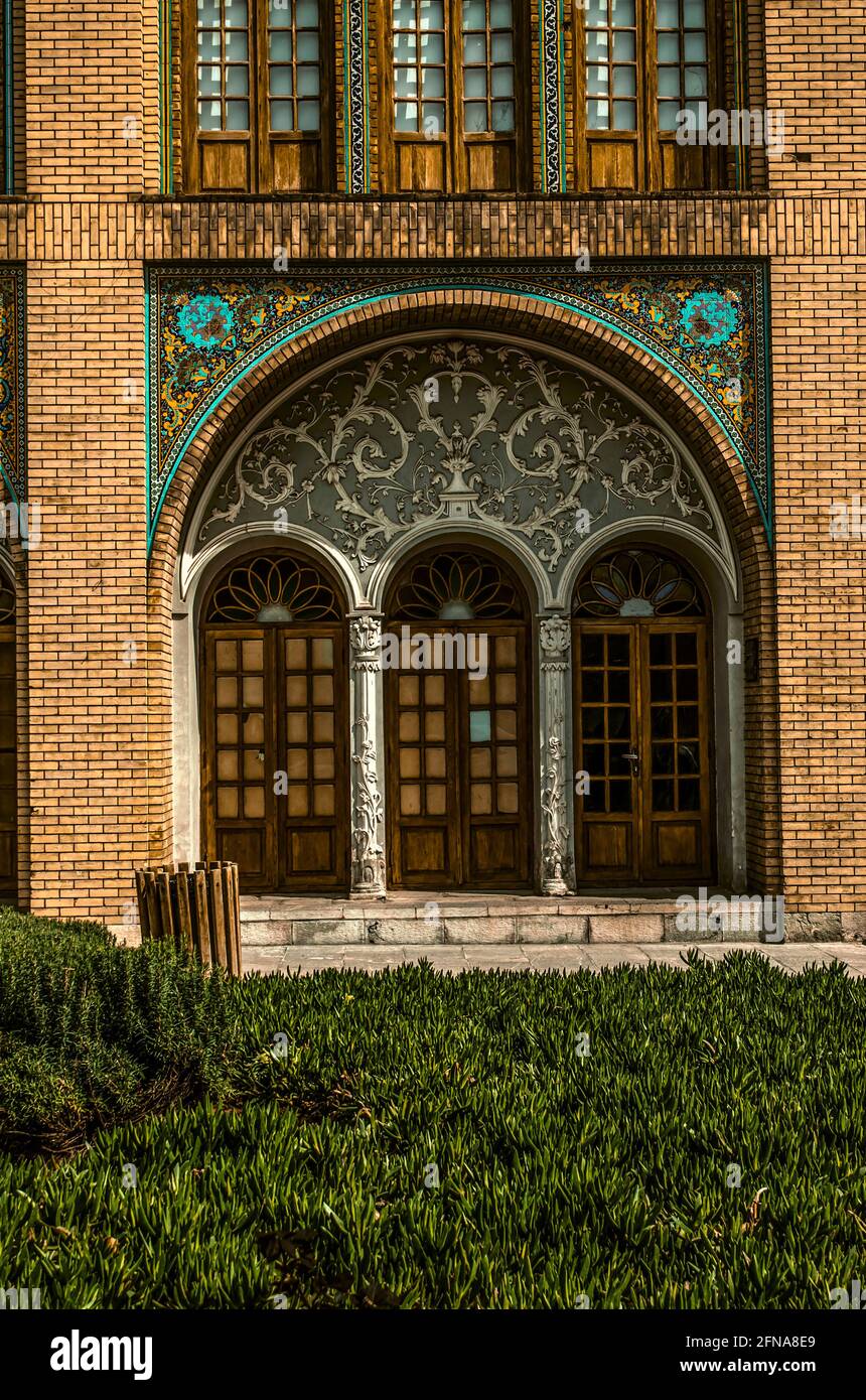 Wall of the Golestan Palace with painted ceramic tiles and an oval ...