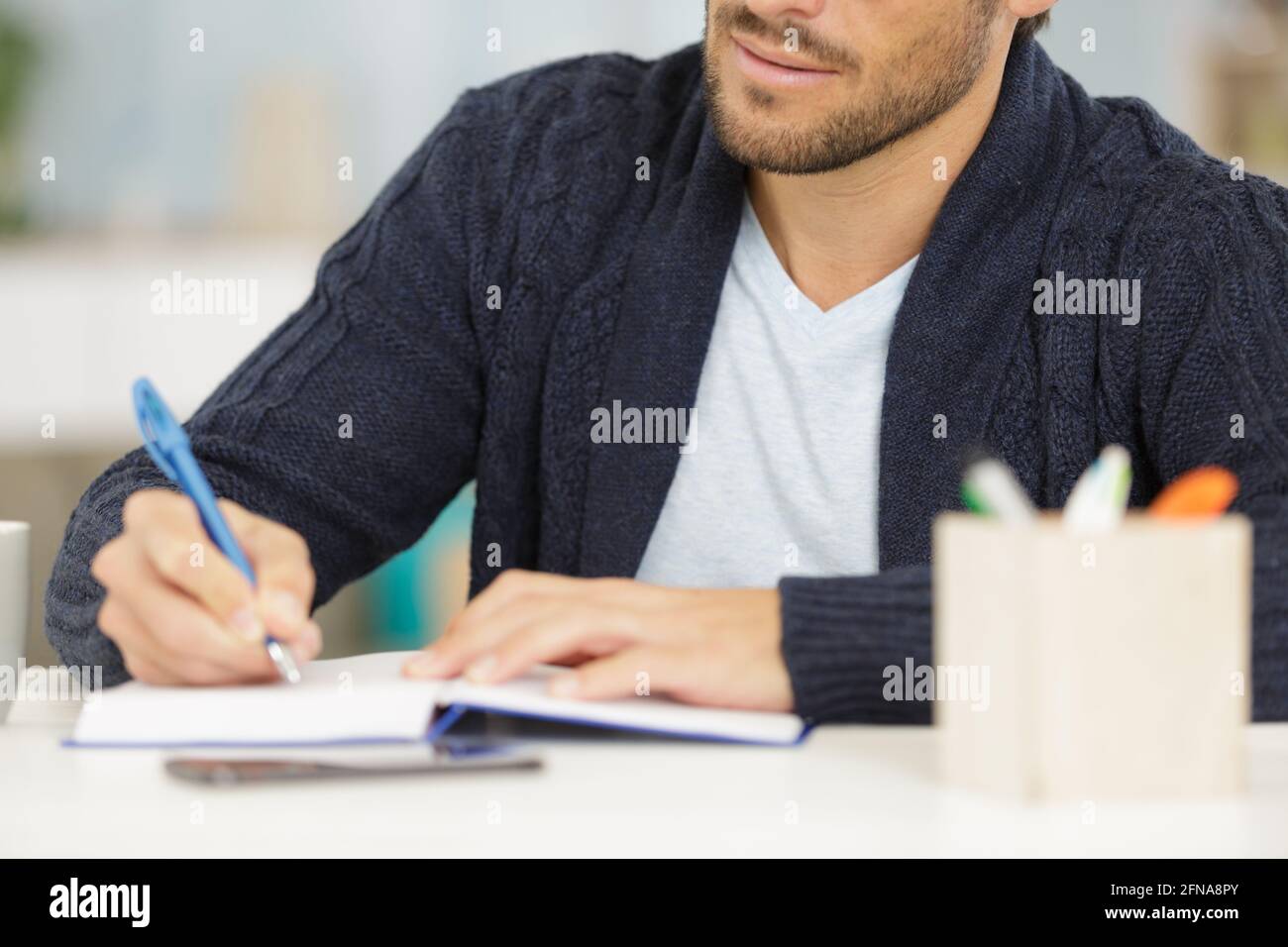 Man taking exam desk writing hi-res stock photography and images - Alamy