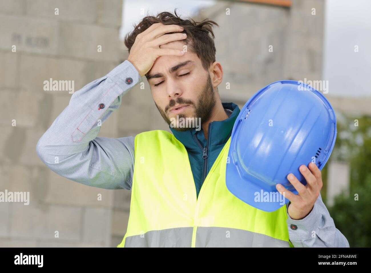 portrait of tensed young constructor feeling exhausted Stock Photo - Alamy