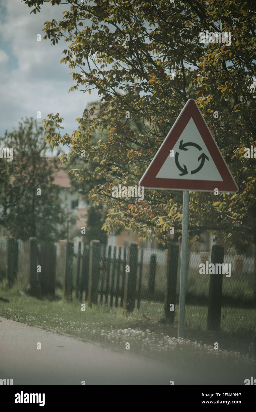 Vertical shot of a triangular roundabout sign on a street Stock Photo ...