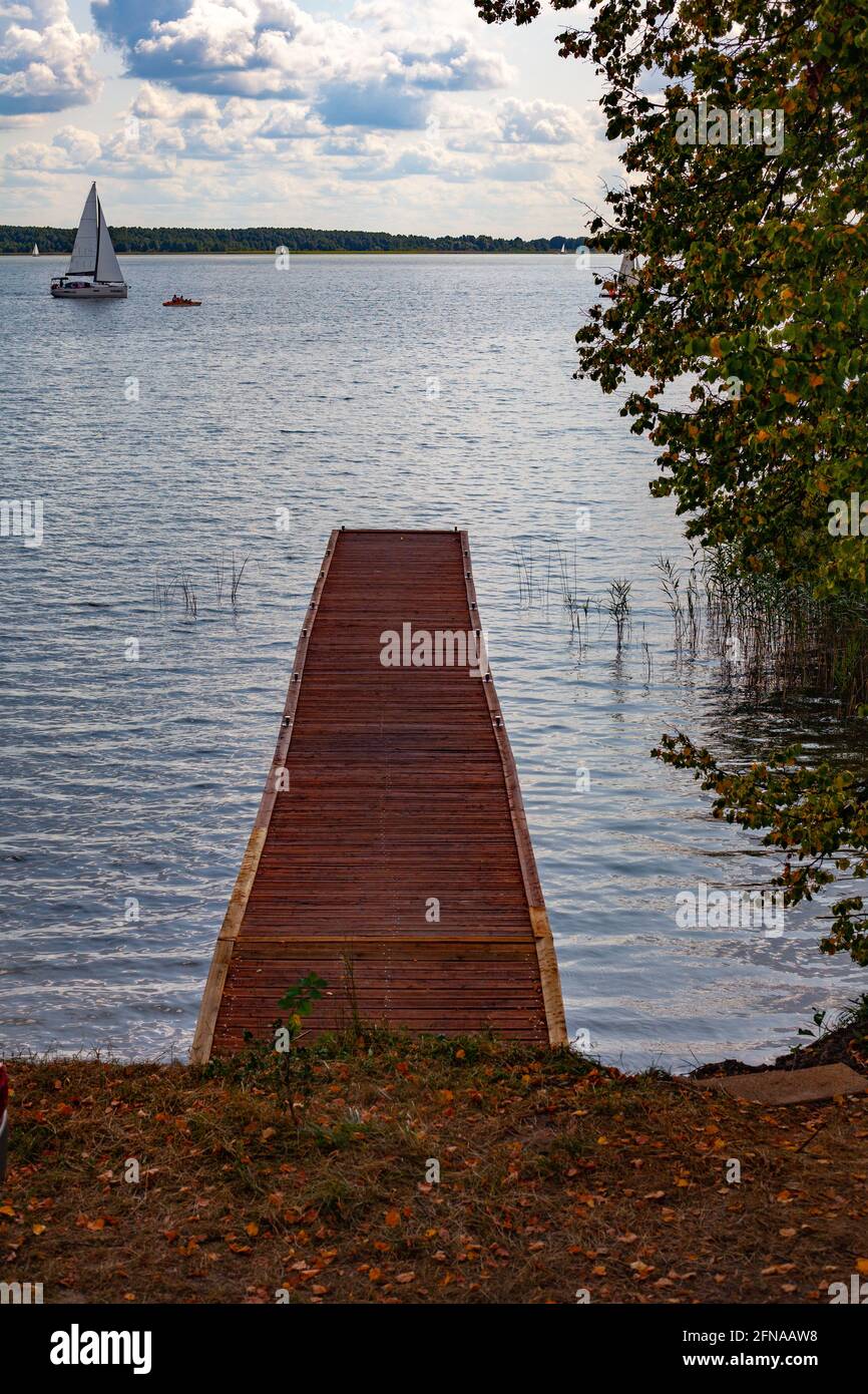Vertical shot of a long wooden dock near a lake Stock Photo - Alamy